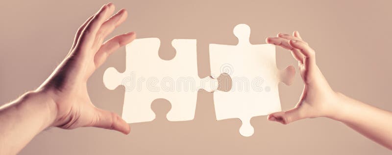 Puzzles. Hand of the Child and Hand of Mother Fold Puzzle, Closeup ...
