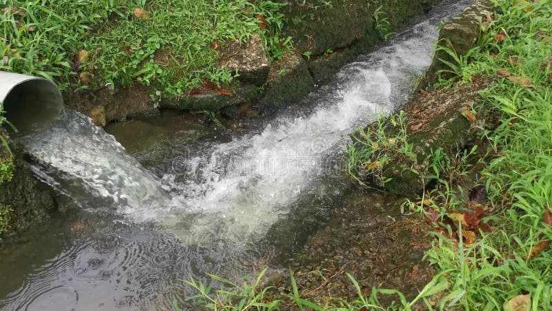 PVC Grey Pipe Gushing Out Freshwater into the Sidewalk Drainage. Stock ...