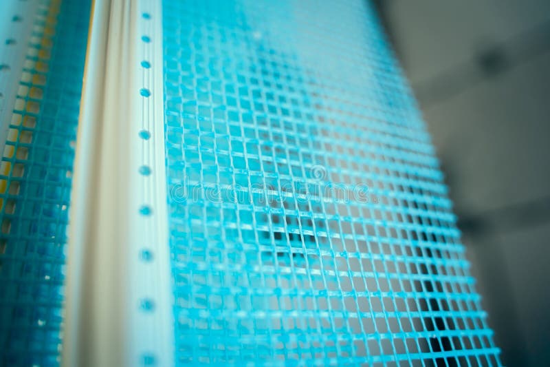 PVC Window Profile with a Cuff and a Blue Mesh Close-up on a Blurred ...