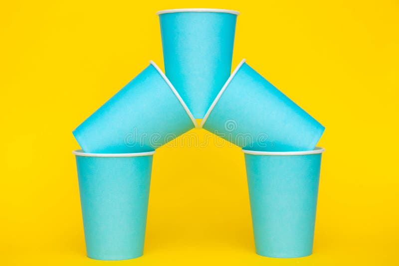 Pyramid of Blue Paper Disposable Cups on Yellow Background. Set for ...