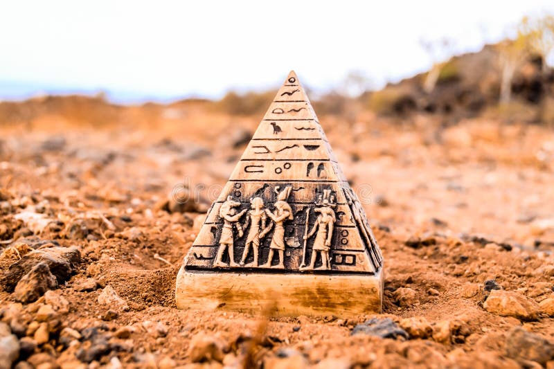 A Pyramid with Hieroglyphics on it Sits on a Desert Plain Stock Photo ...