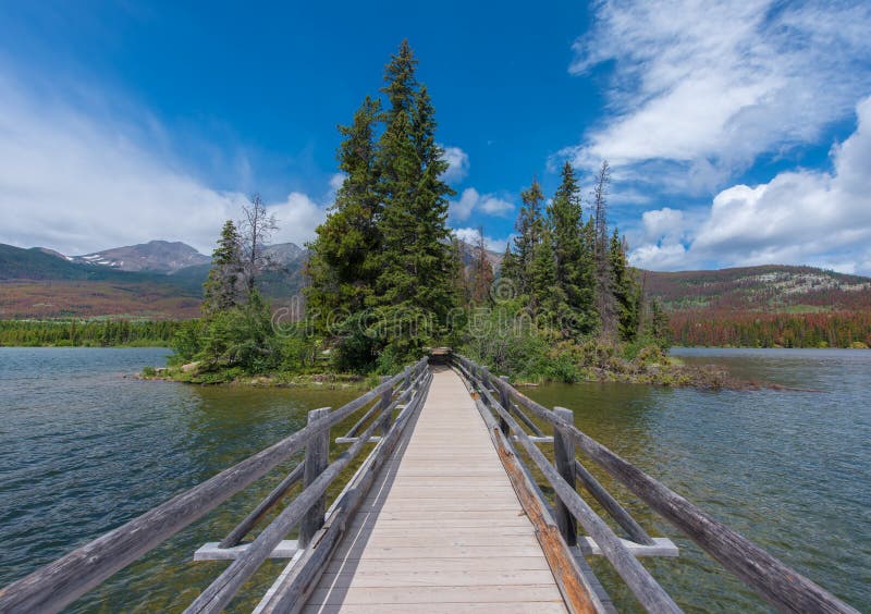 The Pyramid island in spring with color changing background in Alberta ...