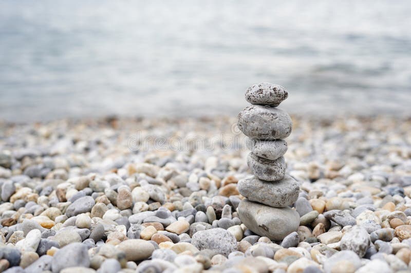Pyramid of Pebbles on the Sea Beach.Waves in Background Stock Image ...
