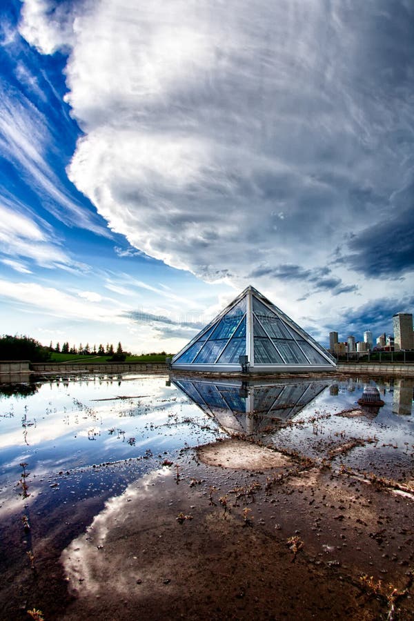 A Pyramid-shaped Building is Reflected in the Water Stock Image - Image ...