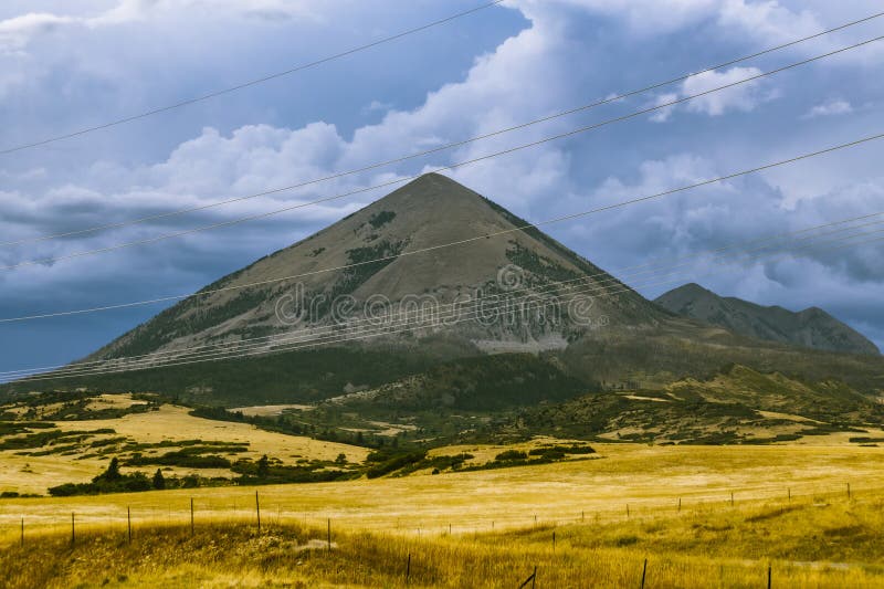 Pyramid-Shaped Peak Under Stormy Skies Stock Image - Image of field ...