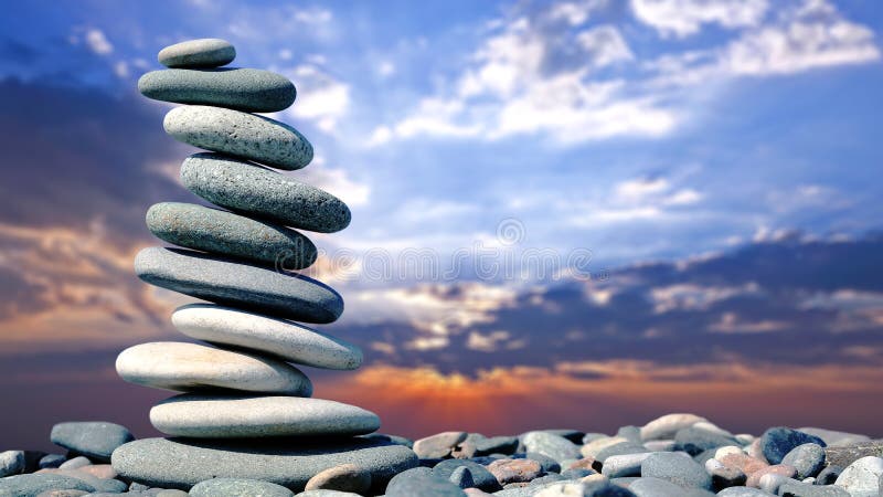 Pyramid of Smooth Stones Against the Backdrop of a Sunset. Natural ...