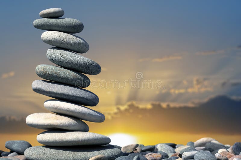 Pyramid of Smooth Stones Against the Backdrop of a Sunset. Natural ...