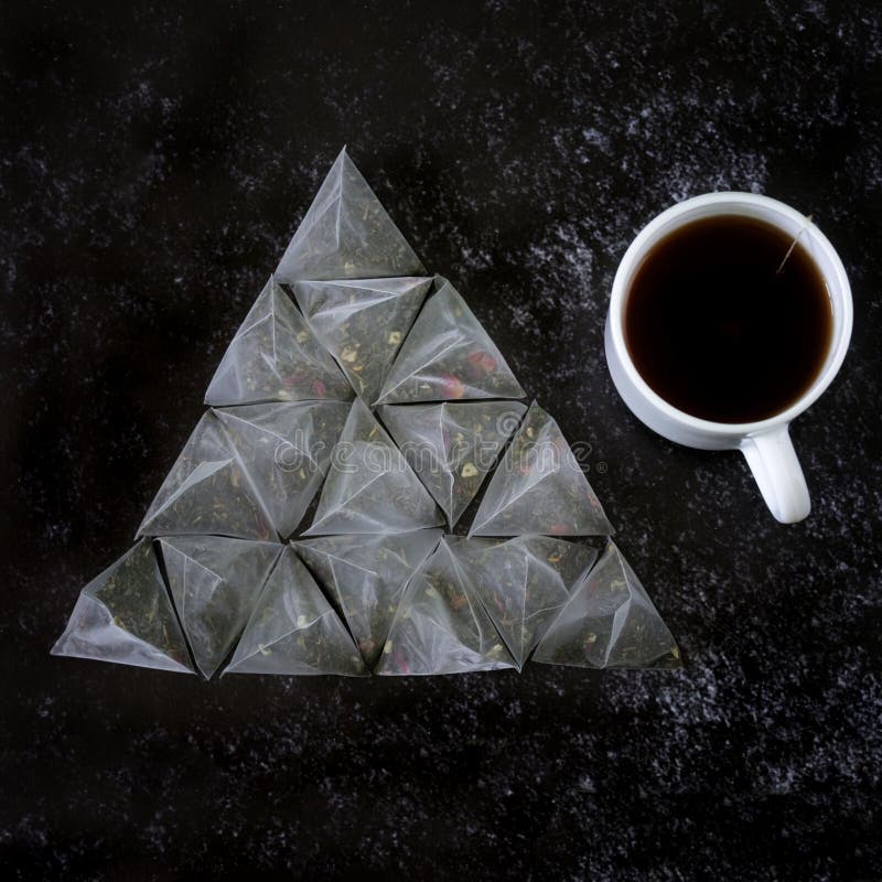 Pyramid Tea Bags with Green Flavored Tea with Fruit and a White Mug on ...