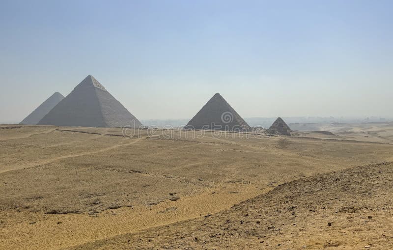 Pyramids of Giza with Blue Sky and Desert in the Foreground Stock Photo ...