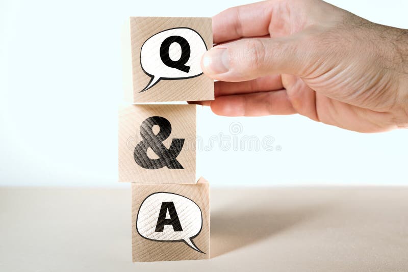 Q and a Question and Answers Concept with Speech Bubbles on Wooden ...