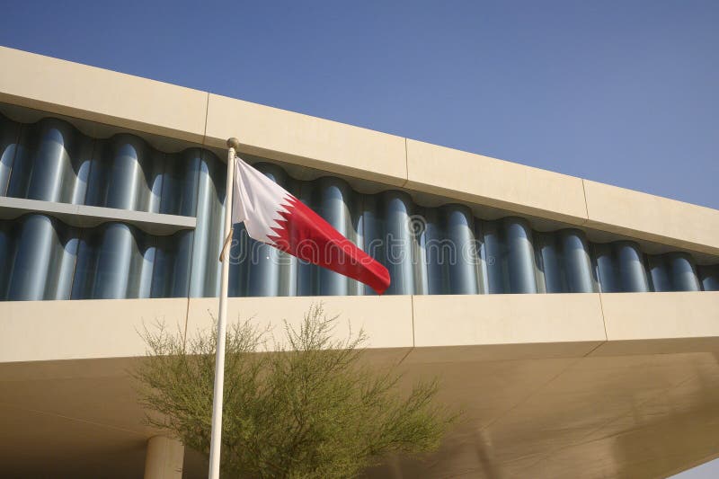 Qatar National Library in Doha with the Qatar Flag Waving Next To it ...