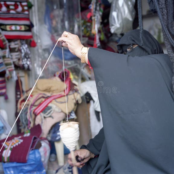 Qatari woman spinning wool editorial photography. Image of textile ...