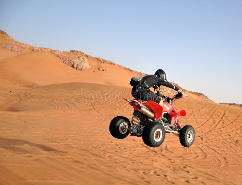 Quad Bike Jumping in the Desert Stock Image - Image of offroad, action ...