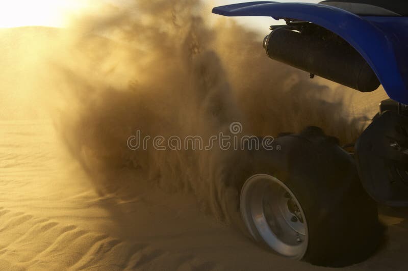 Quad Bike Spraying Up Sand stock photo. Image of immovable - 29650154
