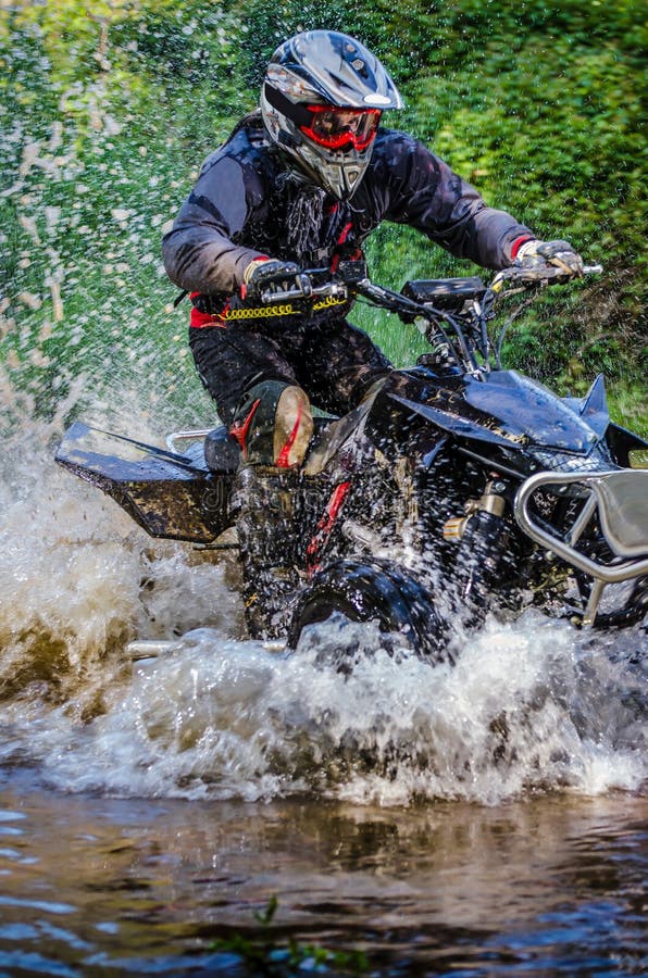 Quad Rider through Water Stream Stock Image - Image of helmet, river ...