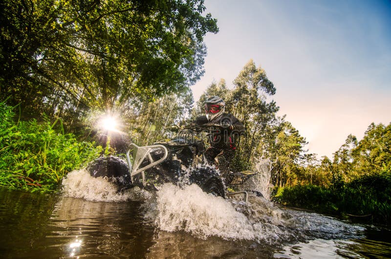 Female Riding ATV through Creek Stock Image - Image of driving ...
