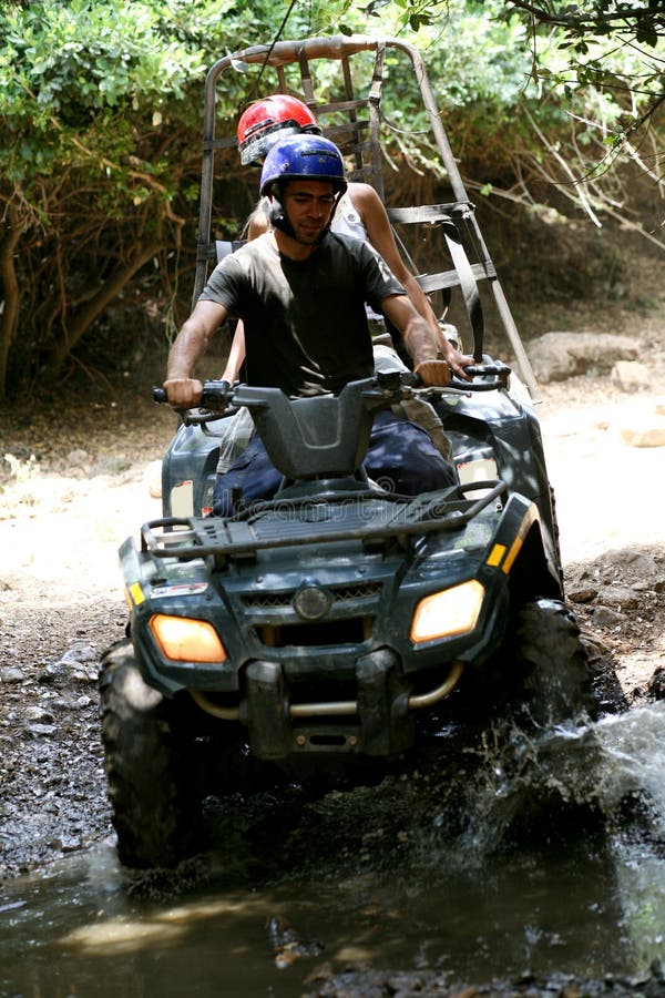 Quadbike splashing water stock image. Image of dangerous - 10524255