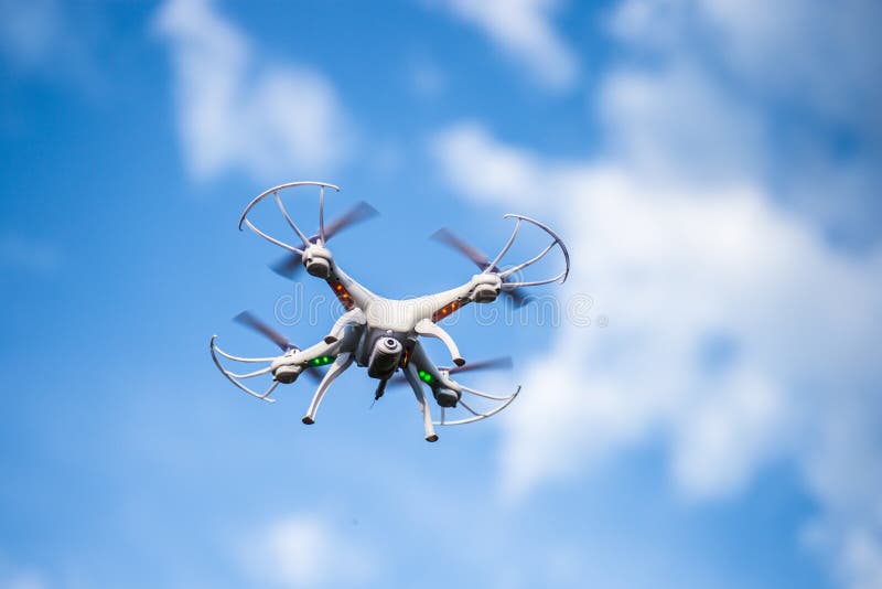 Quadcopter Drone with the Camera Against the Blue Sky. Stock Image ...