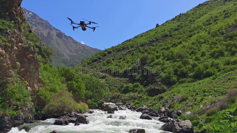 Drone Hovering Above Some Hikers on a Mountain Trail High Above the ...