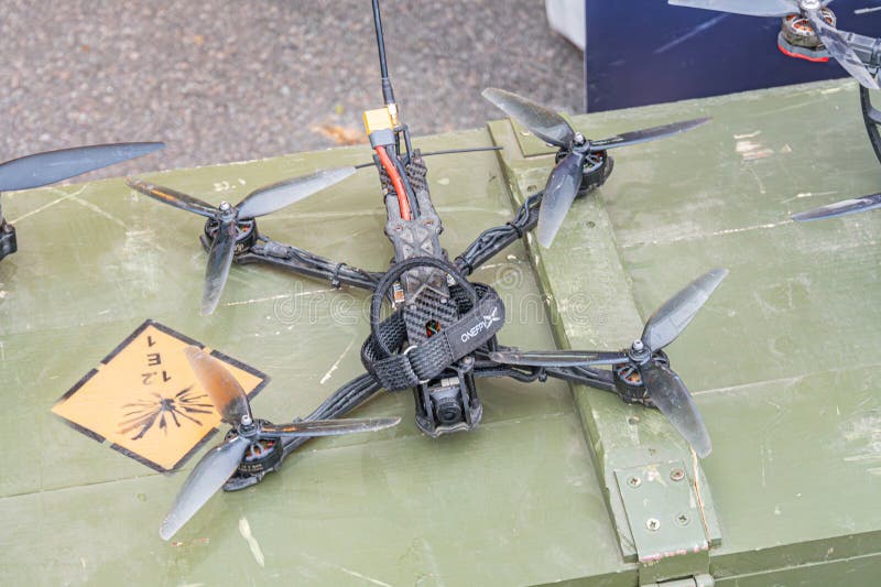 A Quadcopter Drone is Resting on a Green Military Box with a Hazard ...