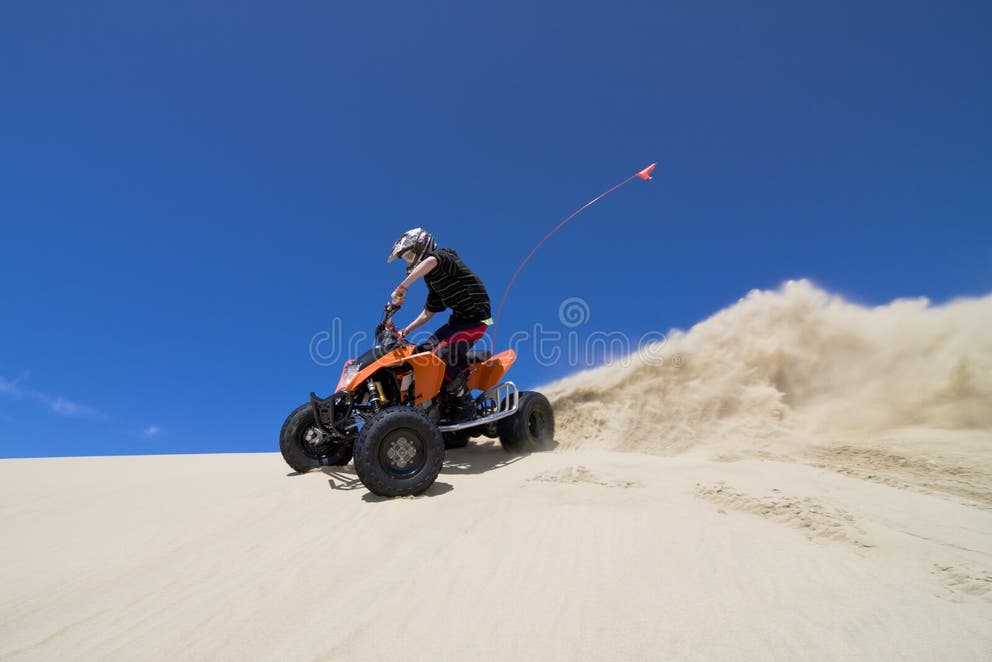 Quadding in sand dunes stock image. Image of blue, lens - 14179847