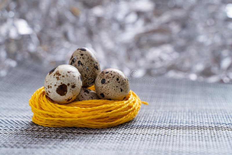 Quail Egg in a Yellow Nest on a Gray Table Cloth Stock Image - Image of ...