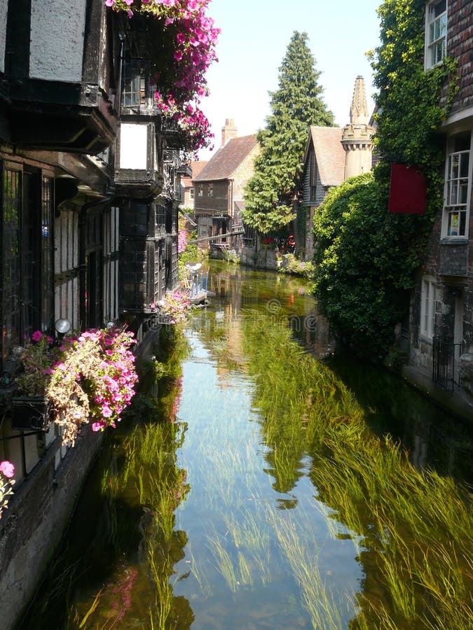 Quaint houses along stream stock photo. Image of town - 12464730