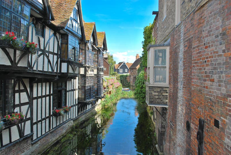 Quaint houses along stream stock photo. Image of town - 12464730