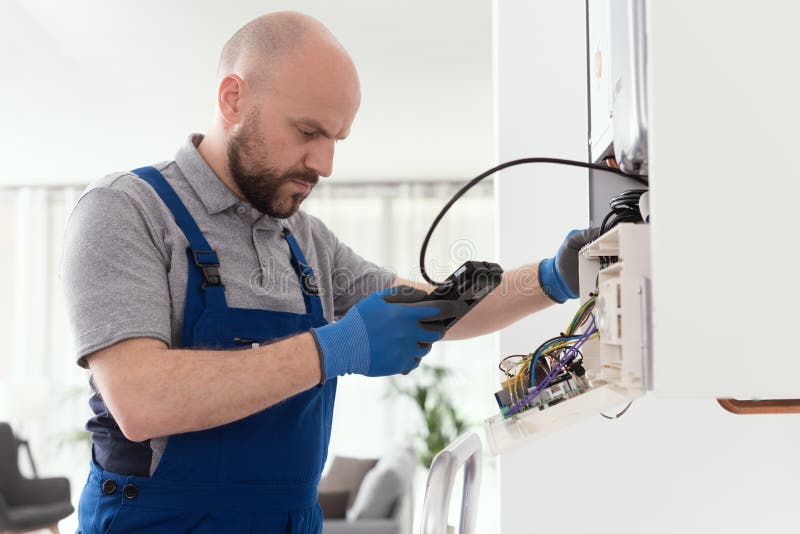 Qualified Engineer Servicing a Boiler Stock Image - Image of measuring ...