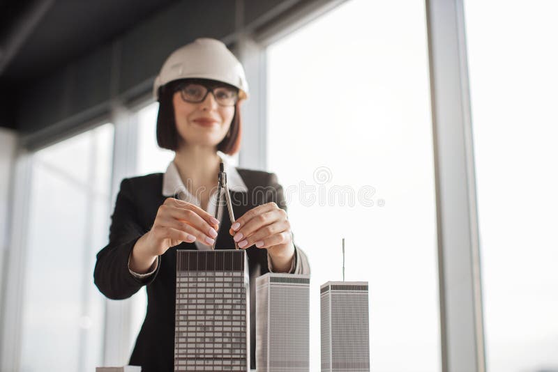 Qualified Female Architect, Engineer in Suit and Hard Hat Measuring ...