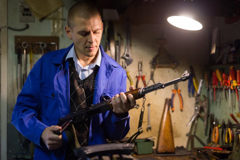 Gunsmith with Kalashnikov Assault Rifle in Weapons Workshop Stock Image ...