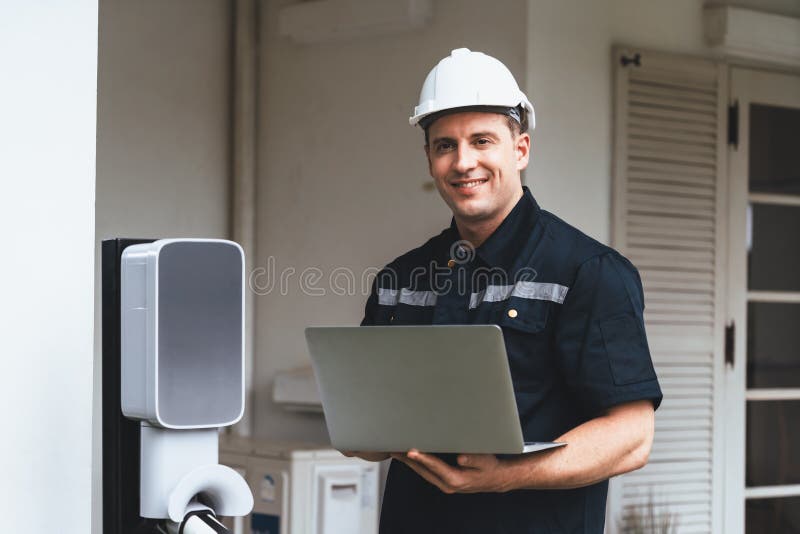 Qualified Technician Working with Laptop for Home EV Station ...