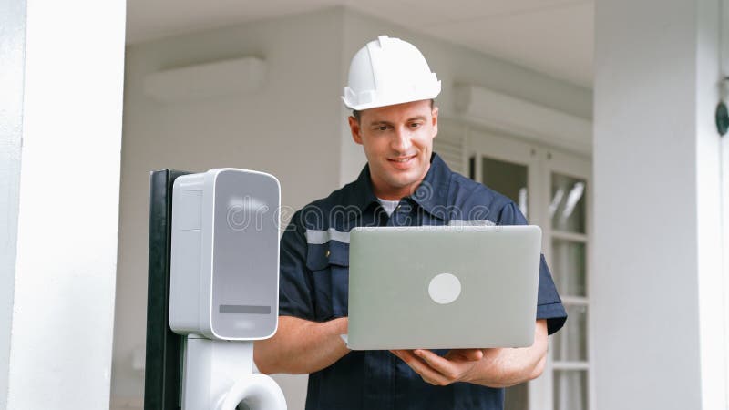 Qualified Technician Working with Laptop for Home EV Station ...