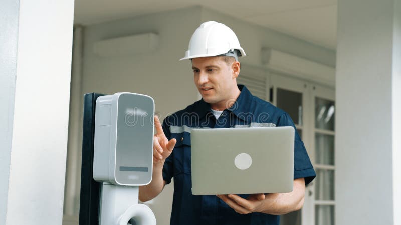 Qualified Technician Working with Laptop for Home EV Station ...