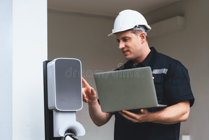 Qualified Technician Working with Laptop for Home EV Station ...