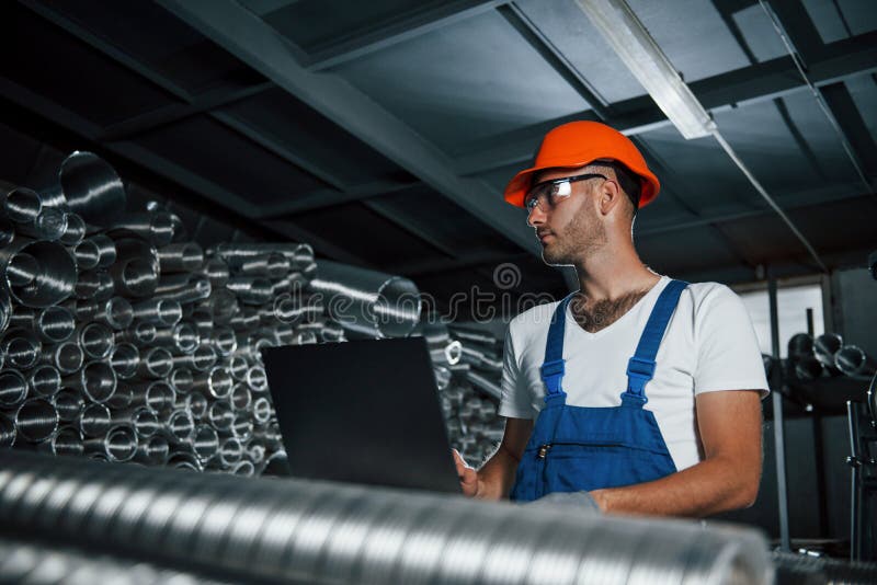 Quality Control. Man in Uniform Works on the Production Stock Photo ...
