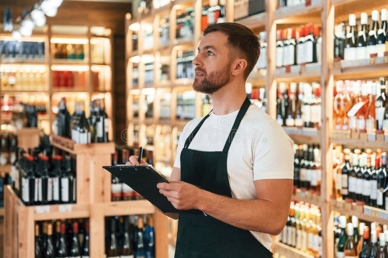 Quality Control, with Notepad. Wine Shop Owner in White Shirt and Black ...