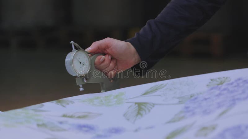 Quality Control of Wallpaper in a Factory, Checking the Thickness of ...