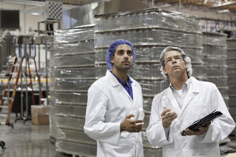 Quality Control Workers Inspecting at Bottling Plant Stock Photo ...