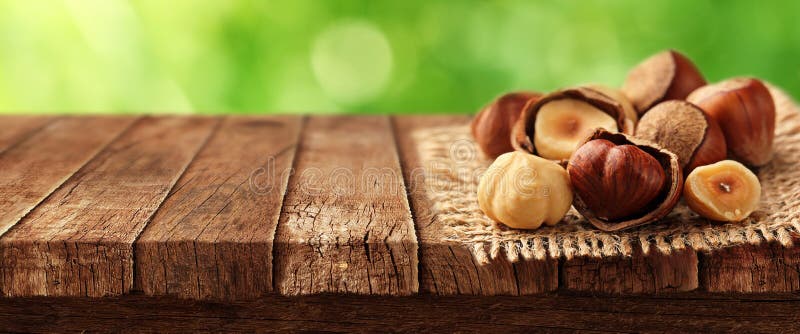 Nuts on Wooden Table and Nature in Background Stock Photo - Image of ...