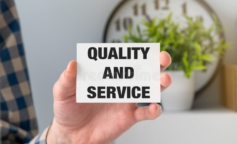 QUALITY and SERVICE Text on a Paper Chart in Hand Businessman Stock ...