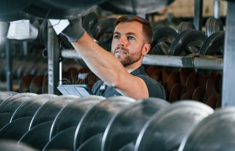 Quality Test. Man in Uniform is in Workstation Developing Details of ...