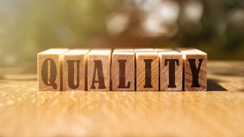 Quality Word Made with Building Wooden Blocks on Table in Sunlight ...