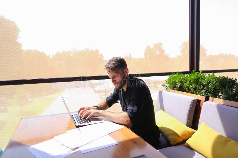 Quantity Surveyor Working at Cafe Table with Papers and Laptop. Stock ...