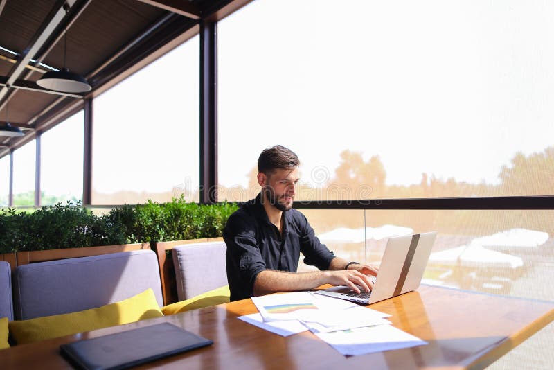 Quantity Surveyor Working at Cafe Table with Papers and Laptop. Stock ...