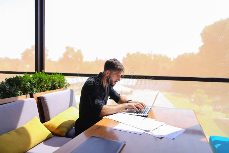 Quantity Surveyor Working at Cafe Table with Papers and Laptop. Stock ...