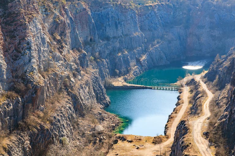 Quarry Lake with Pathway and Dramatic Rocky Cliffs in Sunlight Stock ...