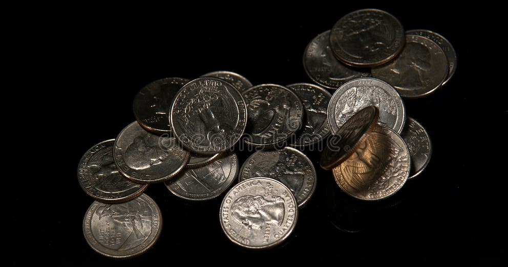 Quarter Dollar Coins Falling, Rolling and Sliding on Black Background ...