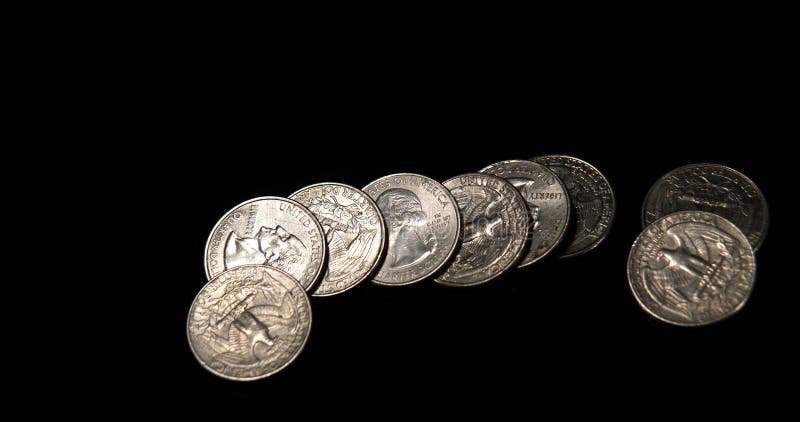 Quarter Dollar Coins Falling, Rolling and Sliding on Black Background ...