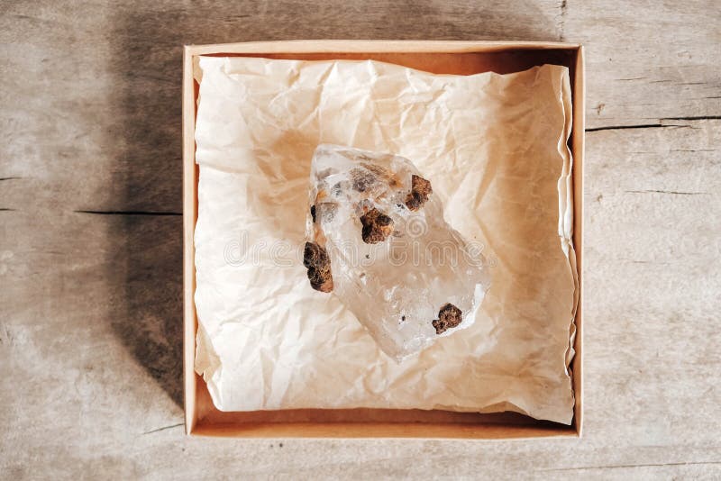 Quartz Crystal in a Kraft Paper Box on Wooden Background. Top View ...